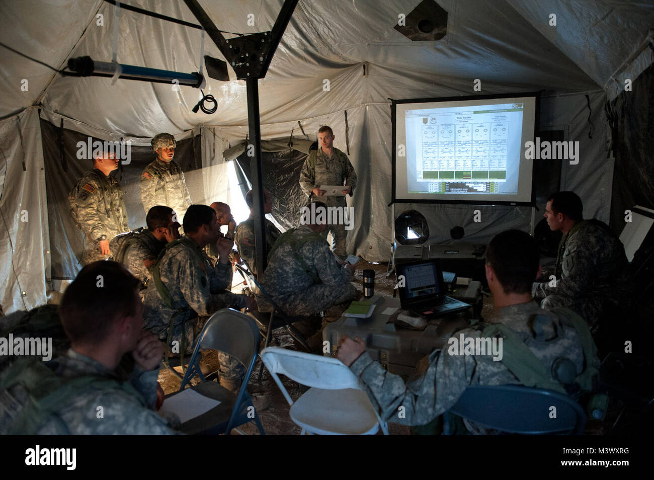 Staff Sgt. Christopher Dearborn (back center) briefs Soldiers during ...