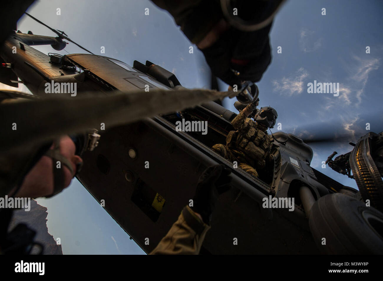 An Air Force pararescueman is hoisted to an HH-60 Pave Hawk during a mission in Afghanistan ...
