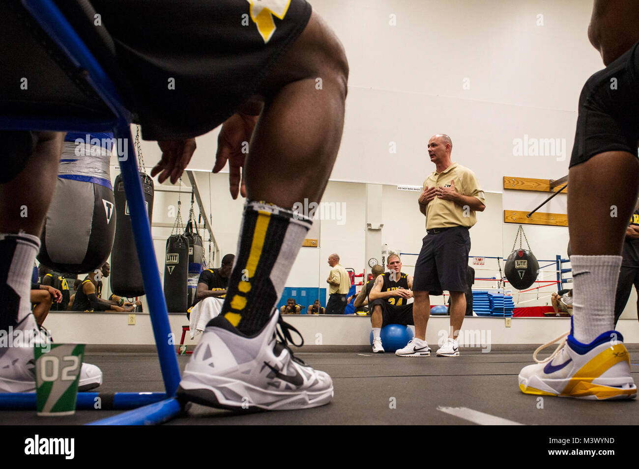 David Smith, standing, All-Army basketball team head coach, talks to ...