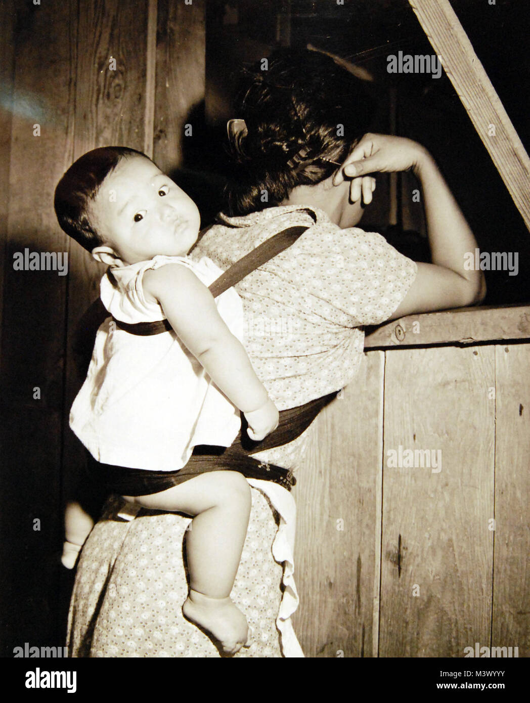 80-G-355095: Mariana Islands, 1945. Japanese baby lashed to his mother ...