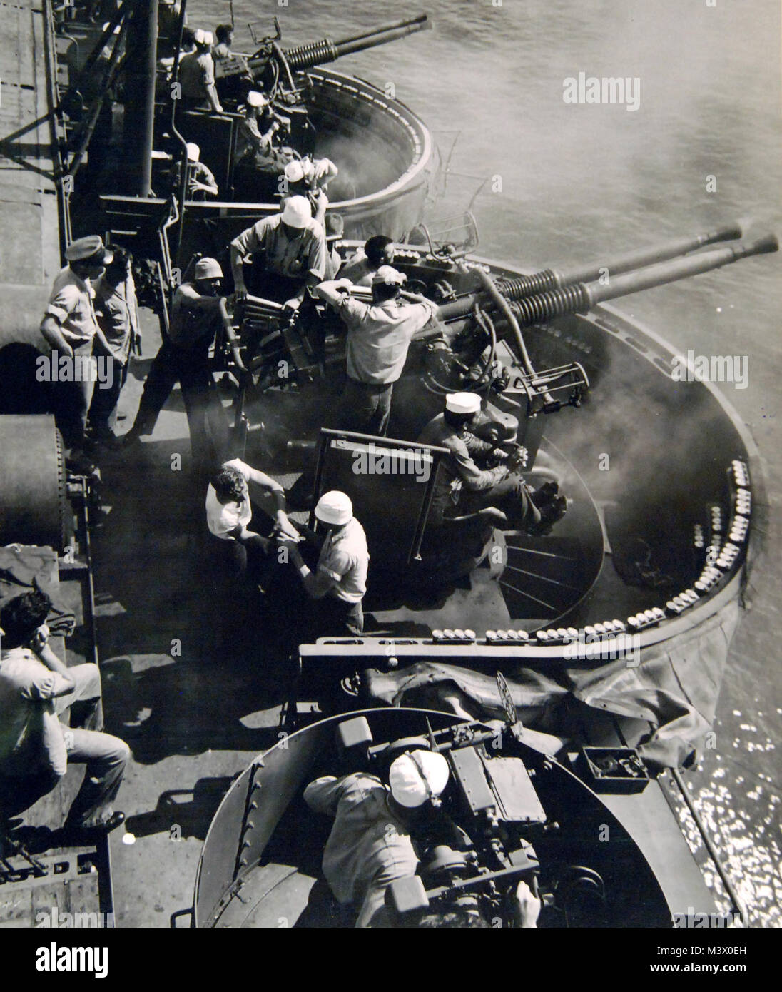 80-G-366332: USS Card (CVE-11), June 25, 1945. 40mm guns firing at ...