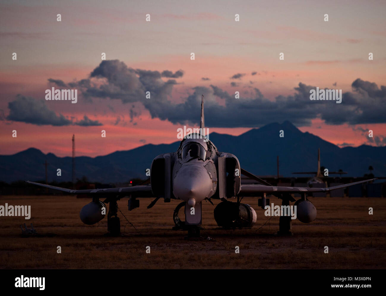 An F-4 Phantom II at sunset inside the "Boneyard." The Phantom has the ...