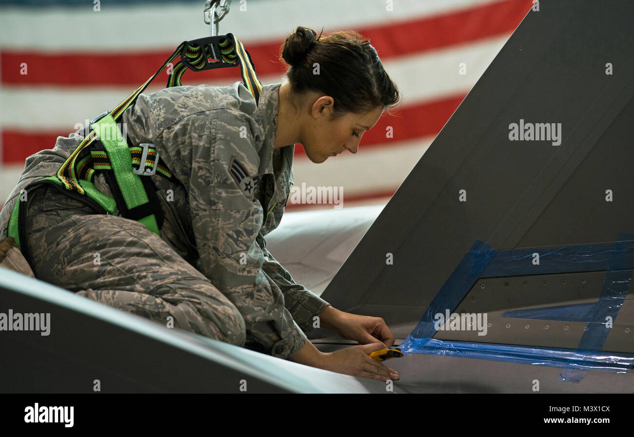 Senior Airman Jessa Fleming, a low observable technician, masks areas ...