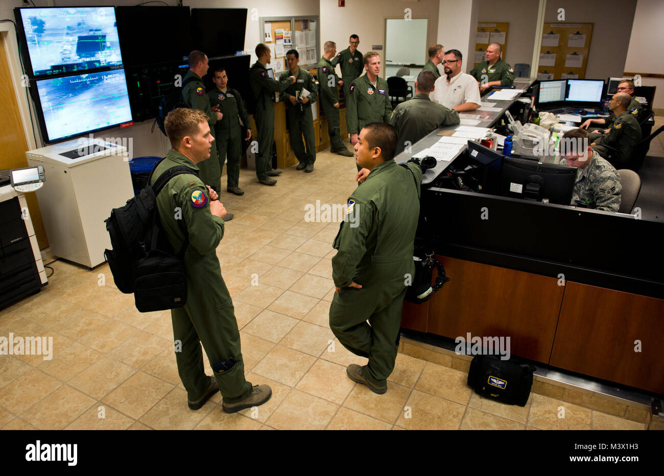 Pilots and sensors assigned to the 9th and 29th Attack Squadron talk to ...
