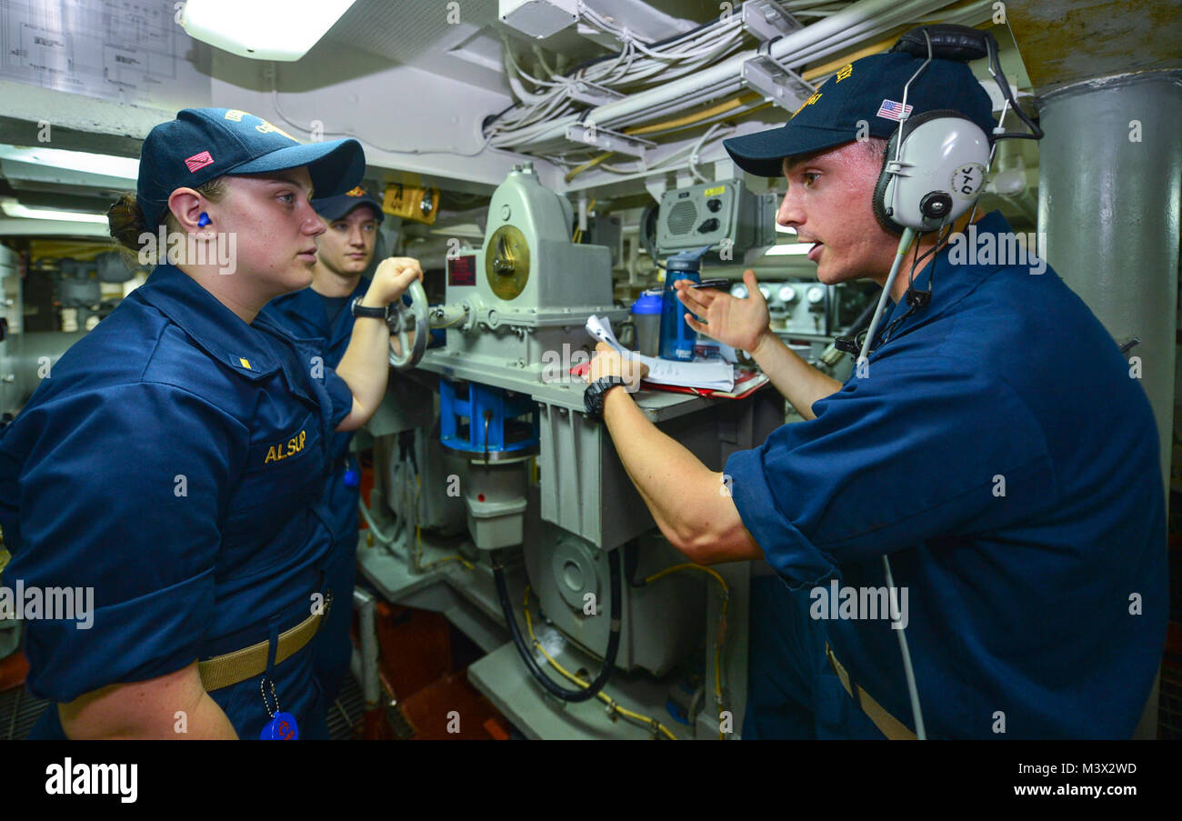 ARABIAN GULF (Aug. 8, 2013) Ensign Michael Ragusa, right, provides ...