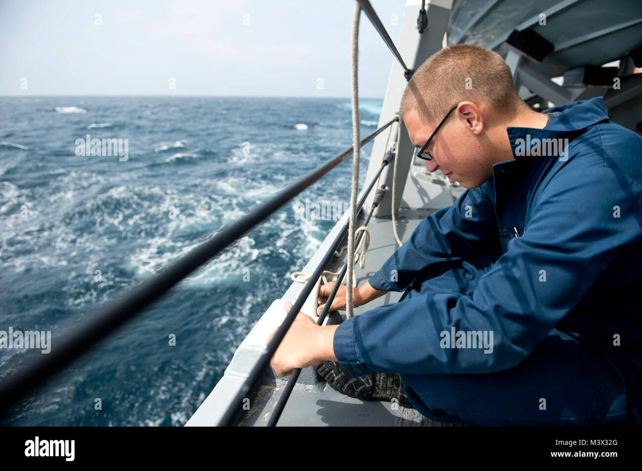 GULF OF OMAN (August 23, 2013) Seaman Jacob Geoffroy ties a line aboard ...