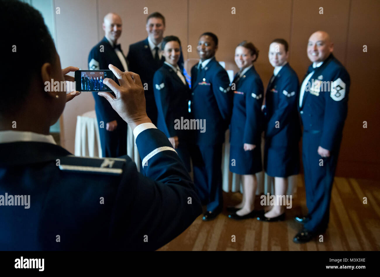 Col. Reba Harris takes a group photo of Chief Master Sgt. Jose Barraza ...