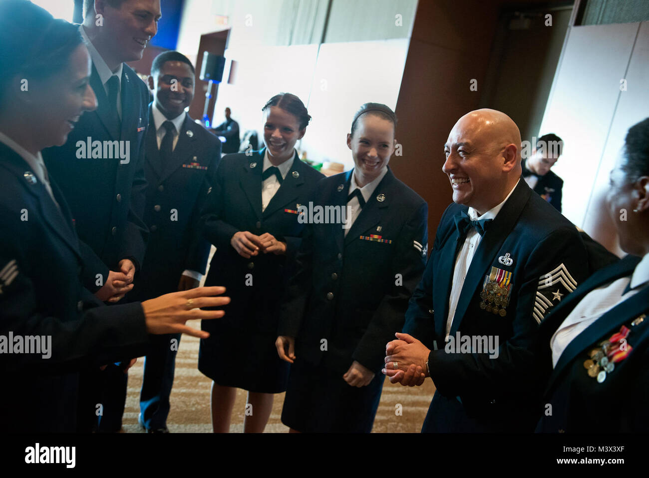 Chief Master Sgt. Jose Barraza shares a laugh with a group of Airmen ...