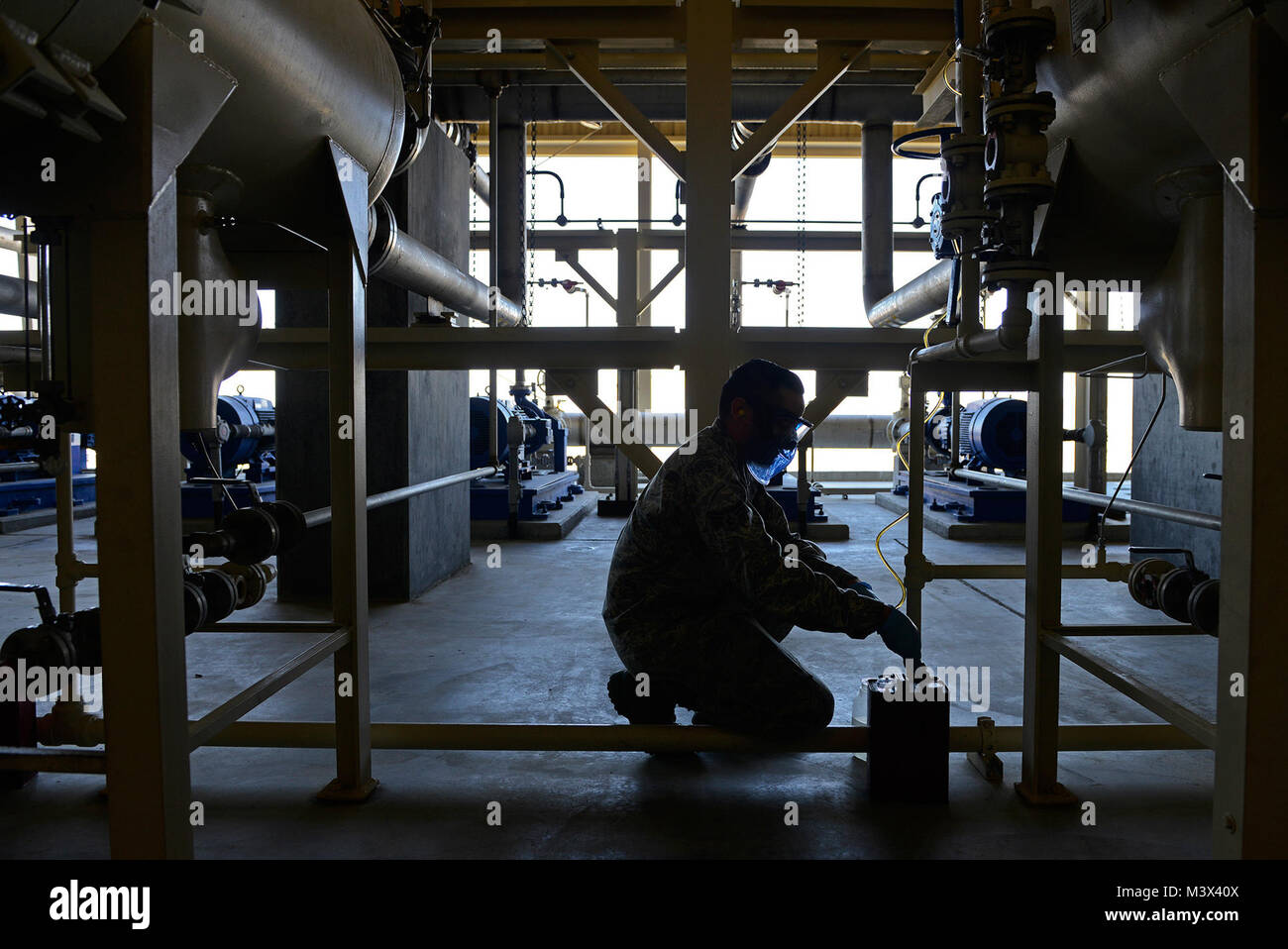 Senior Airman Joshua McKelvey, a fuels lab technician, pulls JP-8 fuel ...