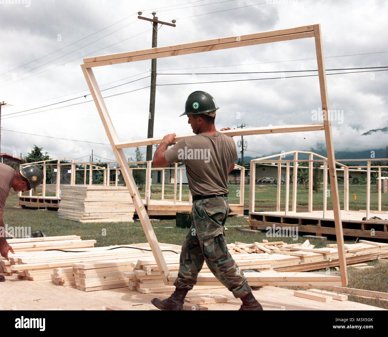 A member of Naval Mobile Construction Battalion Seven (NMCB 7) carries ...