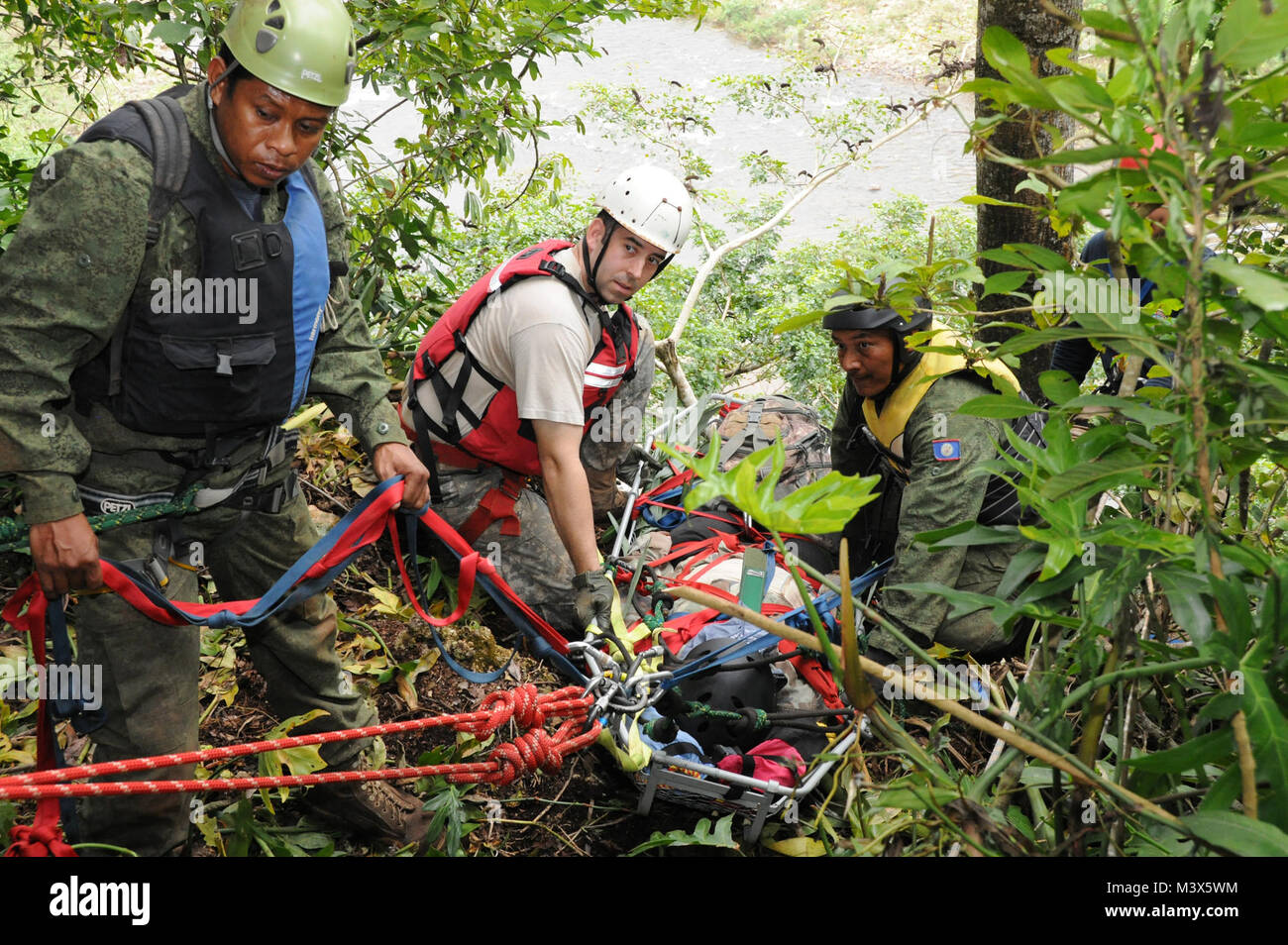 U.S. Army Sgt. Matthew Archilla (center) works with Belize Defense ...