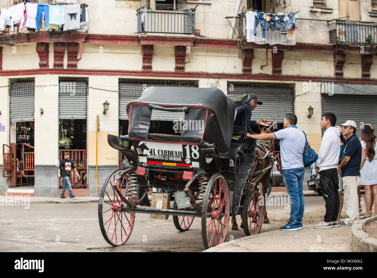 Horse drawn carriage moving tourists in the capital of Cuba Stock Photo ...