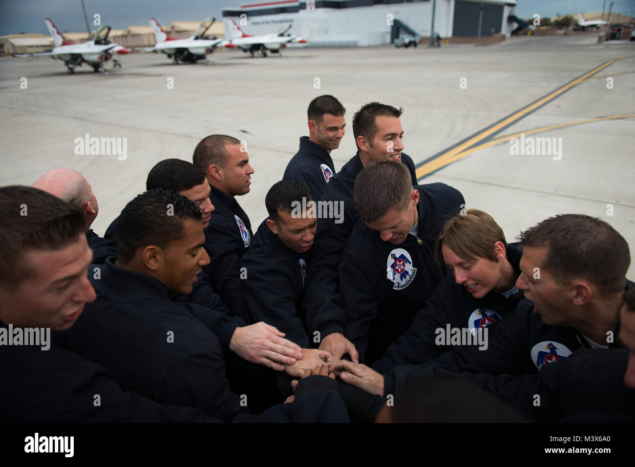 Thunderbirds maintenance personnel huddle up to perform a chant at the ...