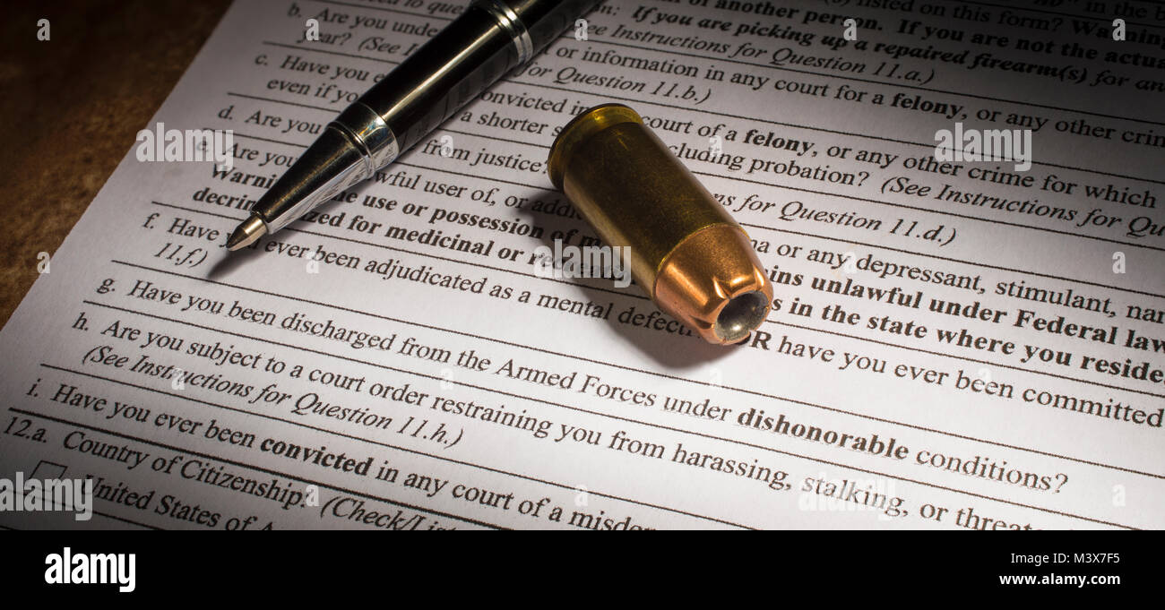 Form for a gun transfer with ammo and pen near question about ...