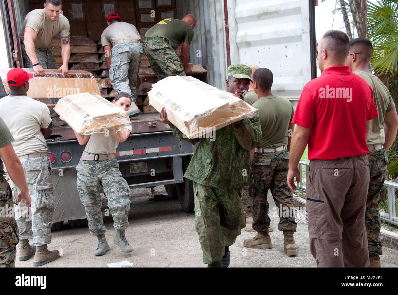 Belize Defence Force and U.S. military members offload school supplies ...