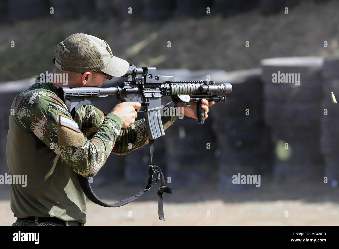 A bullet casing flies when a member of the Colombian assault team fires ...