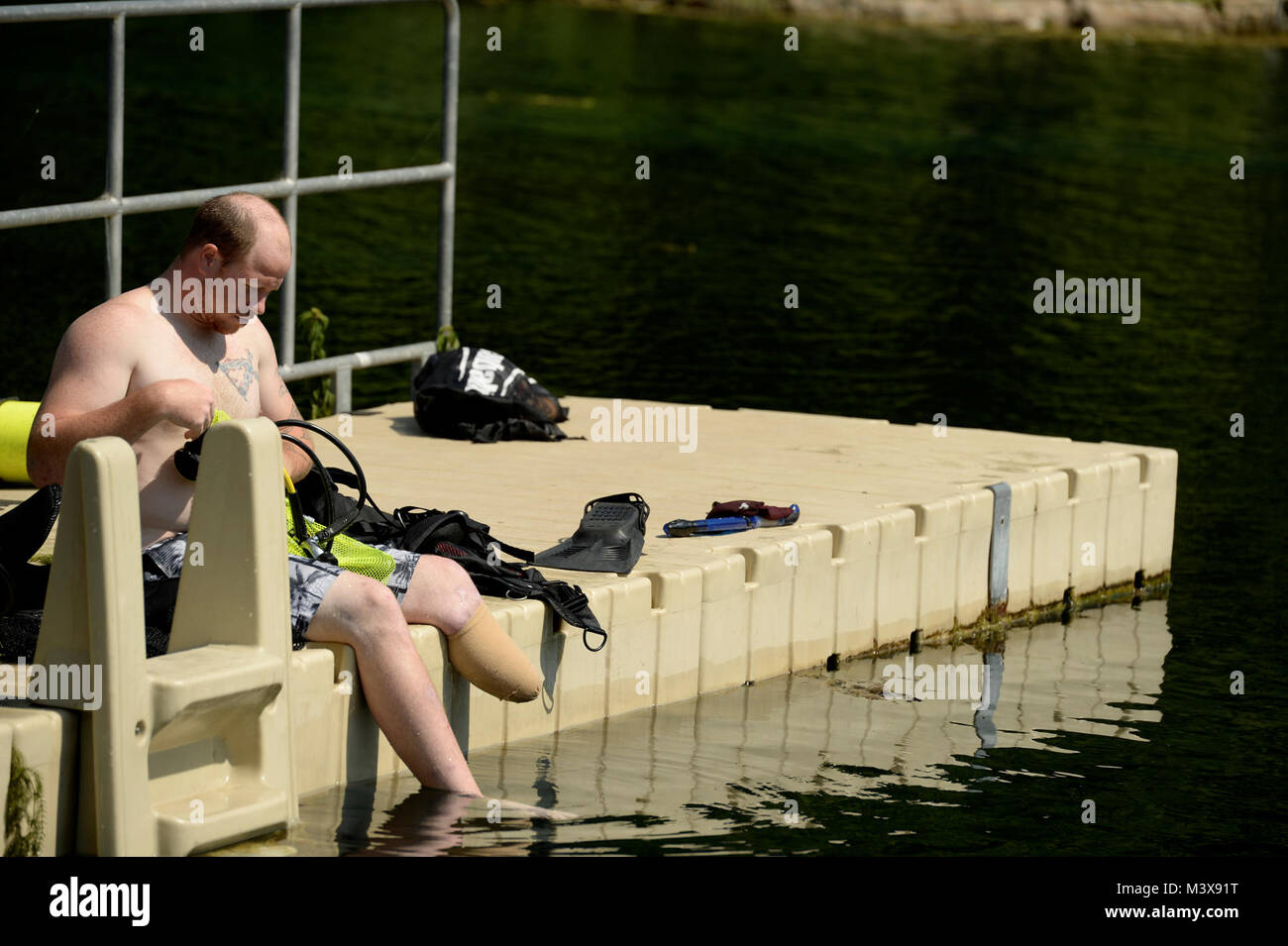 Keith Morlan packs up his scuba gear after participating in a scuba ...