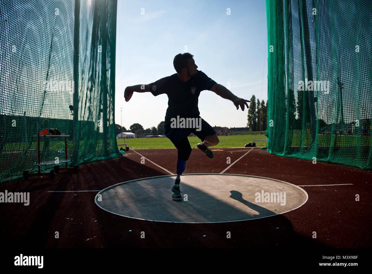 Max Rohn, a retired Navy 3rd Class Petty Officer, winds up to throw a ...