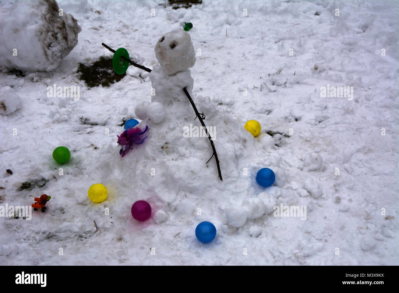 A terrible and ugly snowman made by children in the winter courtyard of ...