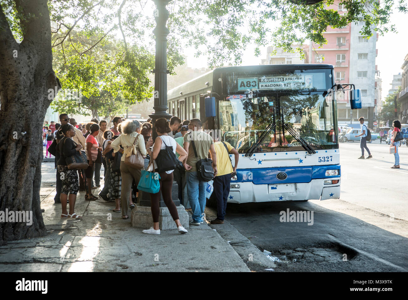 Large group of people boarding a bus in Havana Stock Photo - Alamy