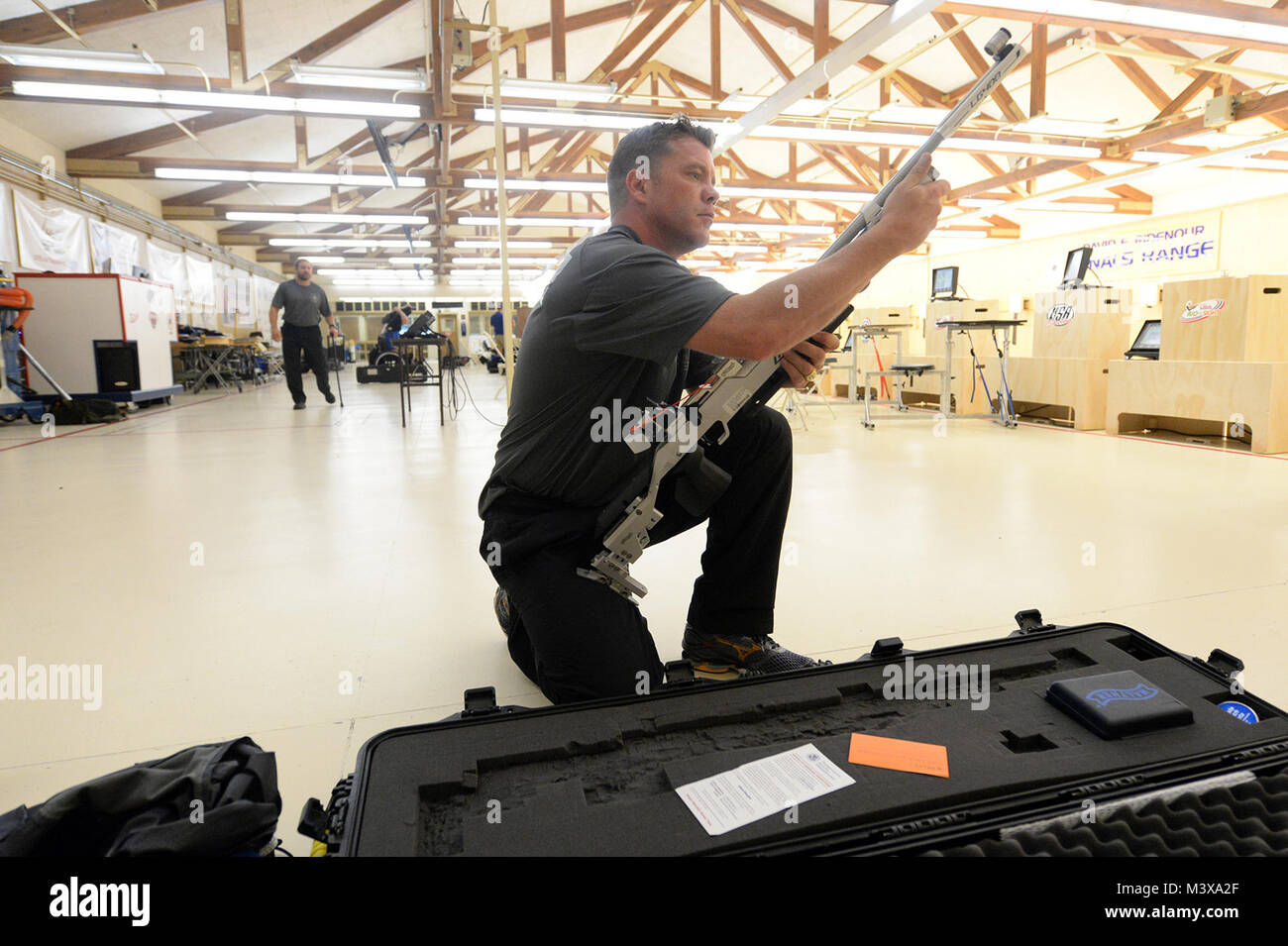 Army Sgt. First Class Joshua Bendell prepares an air rifle during for ...