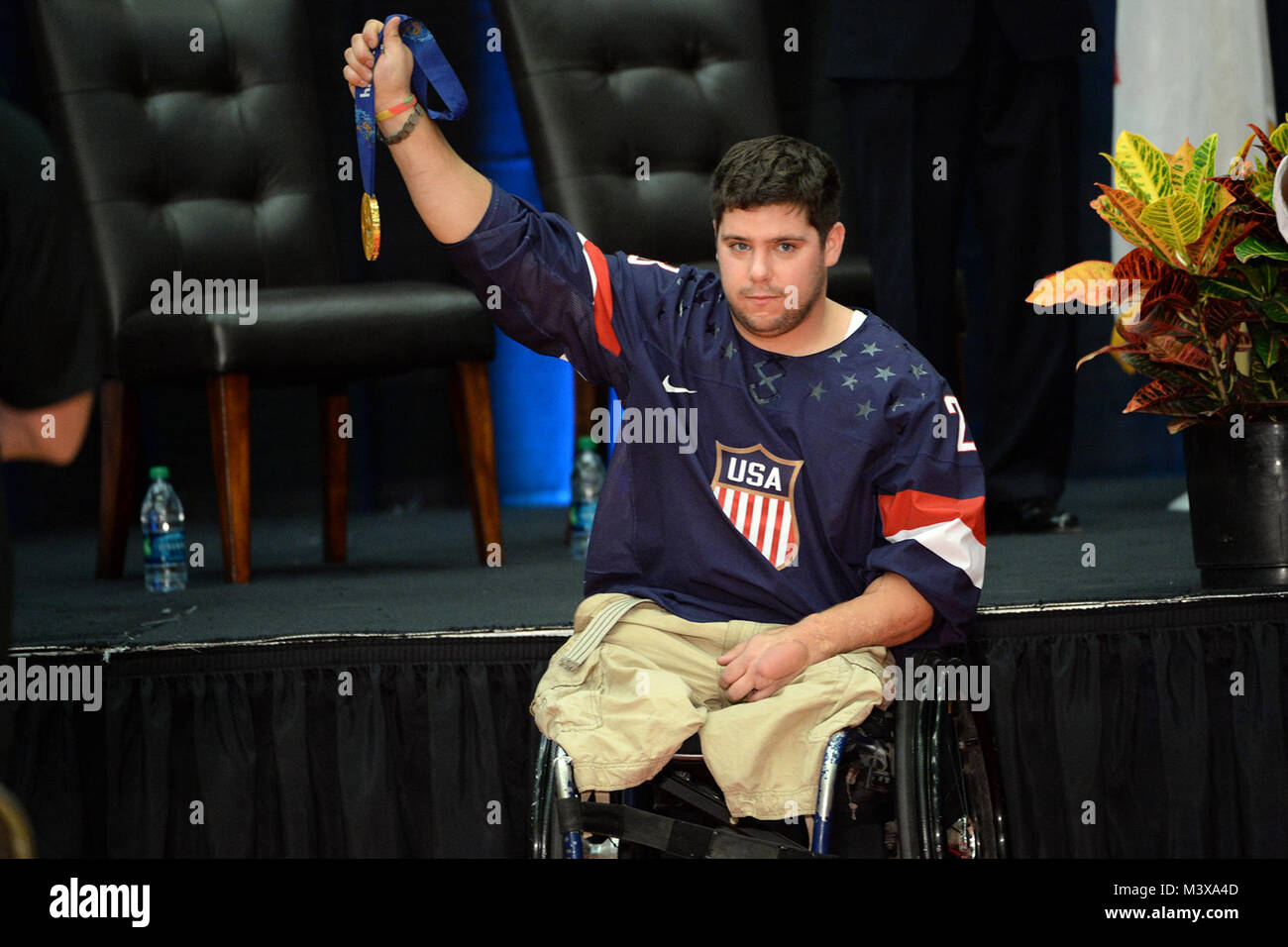Paralympian Gold Medalist Retired Marine Cpl. Paul Schaus holds up his ...