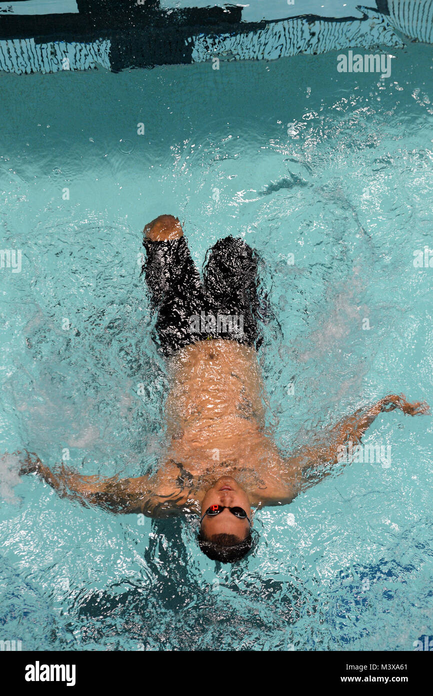Marine Corps team's Jorge Salazar begins the 50 meter backstroke in the ...