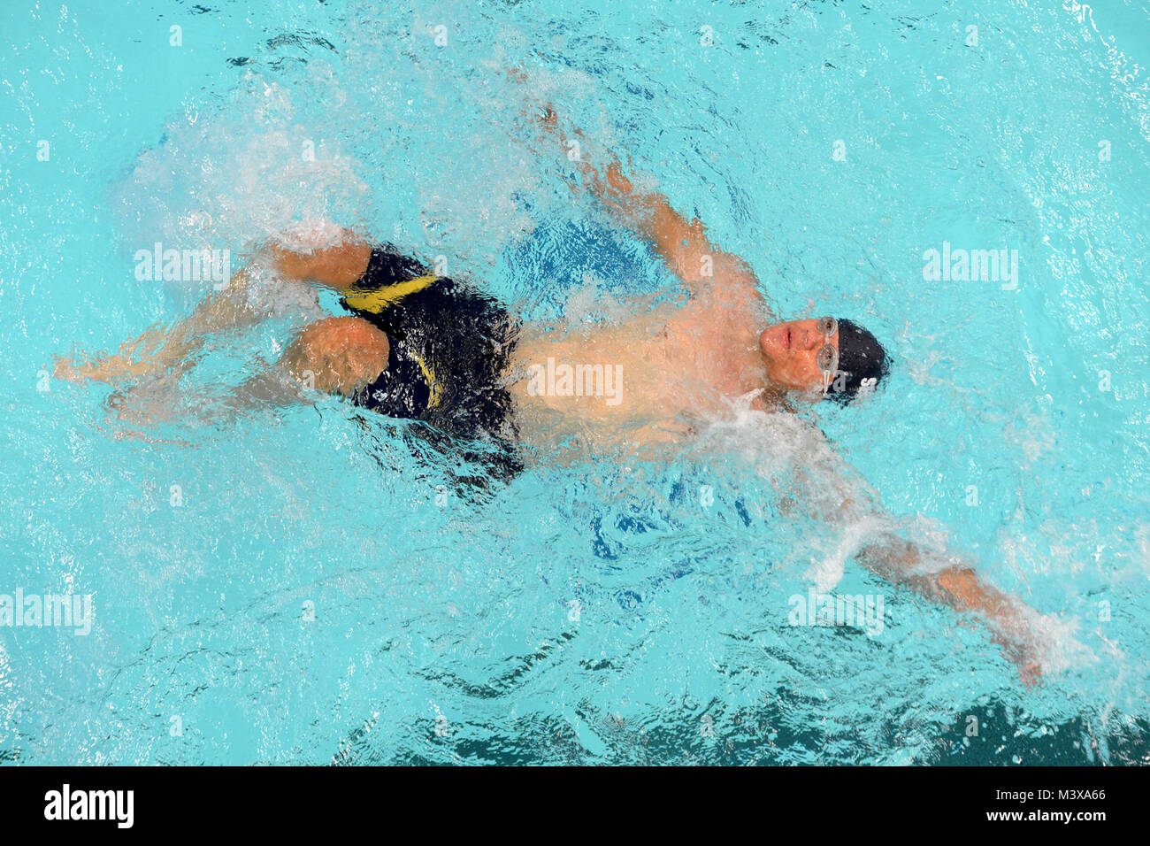 Navy team’s Petty Officer 3rd Class Angel Segarra swims the 50 meter ...