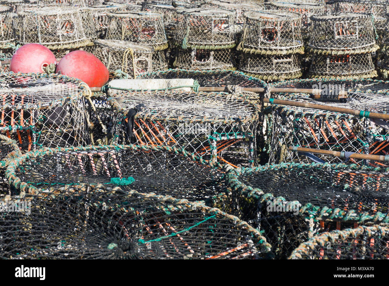 Lobster pots and traps stacked on a quay Stock Photo - Alamy