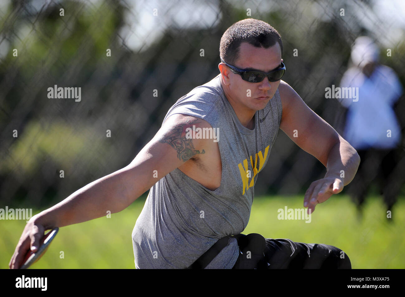 Navy team’s Chief Petty Officer Javier Rodriguez Santiago winds up to ...