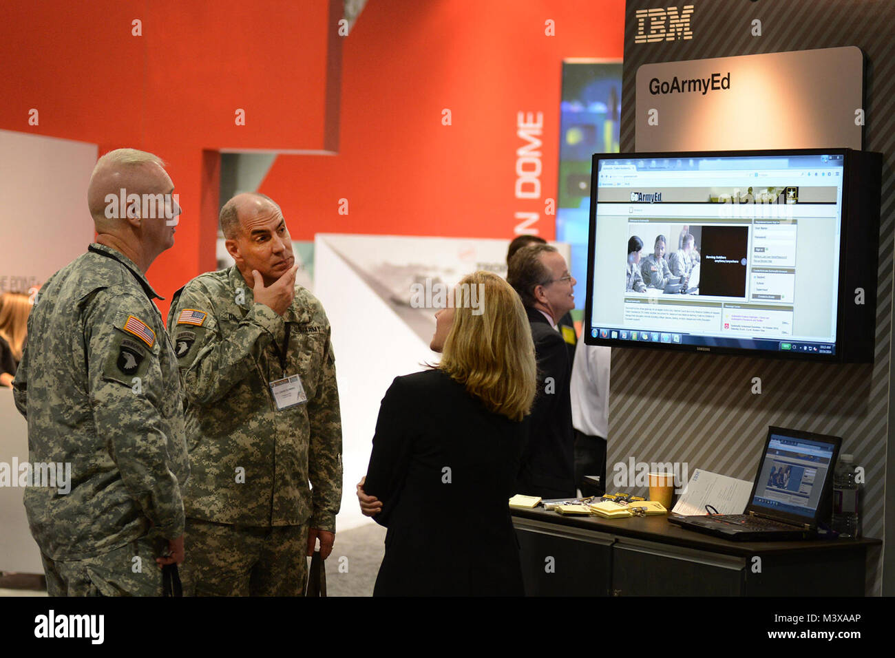 Col. David Dunning visits an IBM booth in Exhibit Hall during 2014 ...