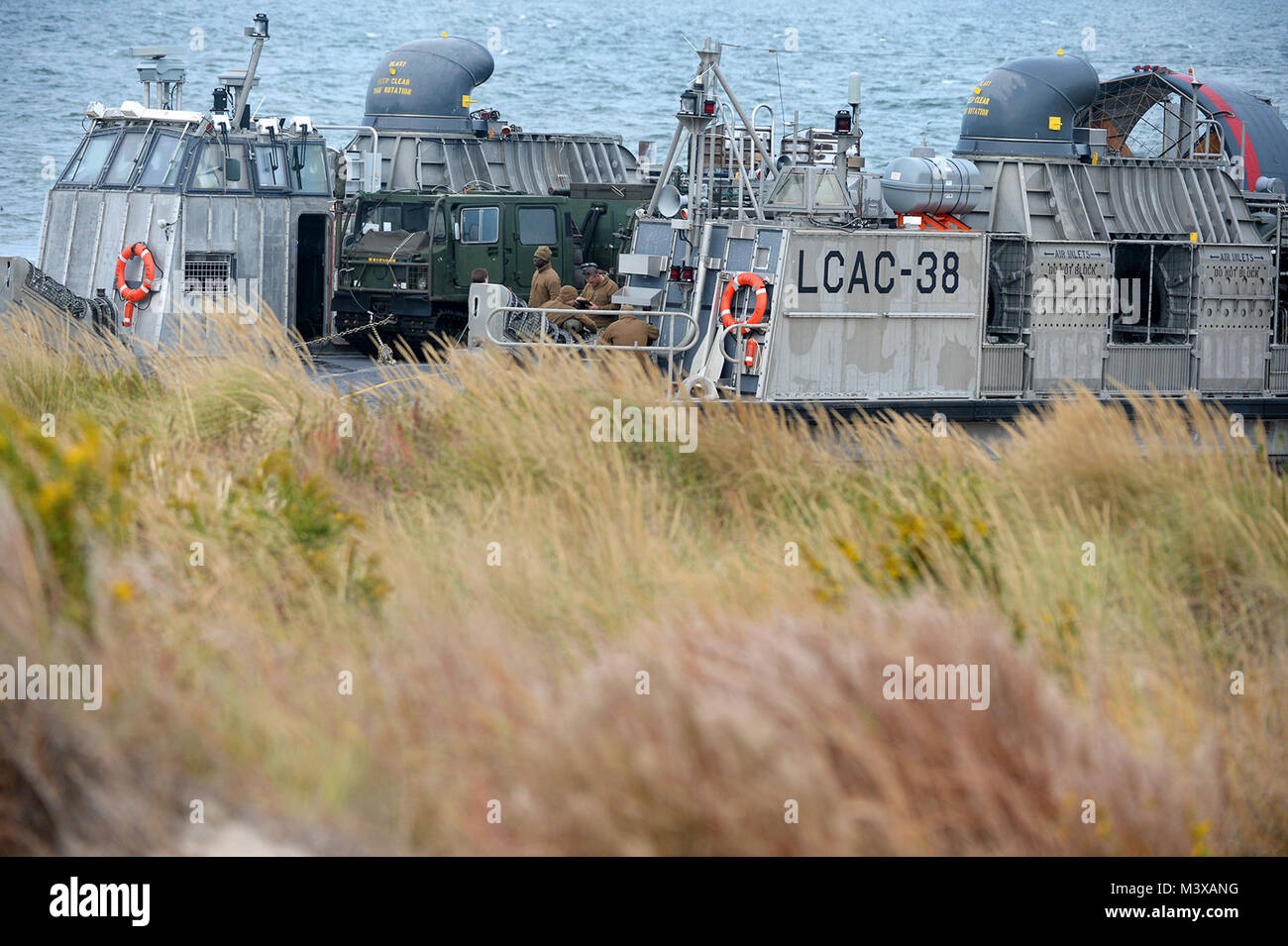 U.S. Navy LCAC (Landing Craft Air Cushioned) crewmembers make plans on ...