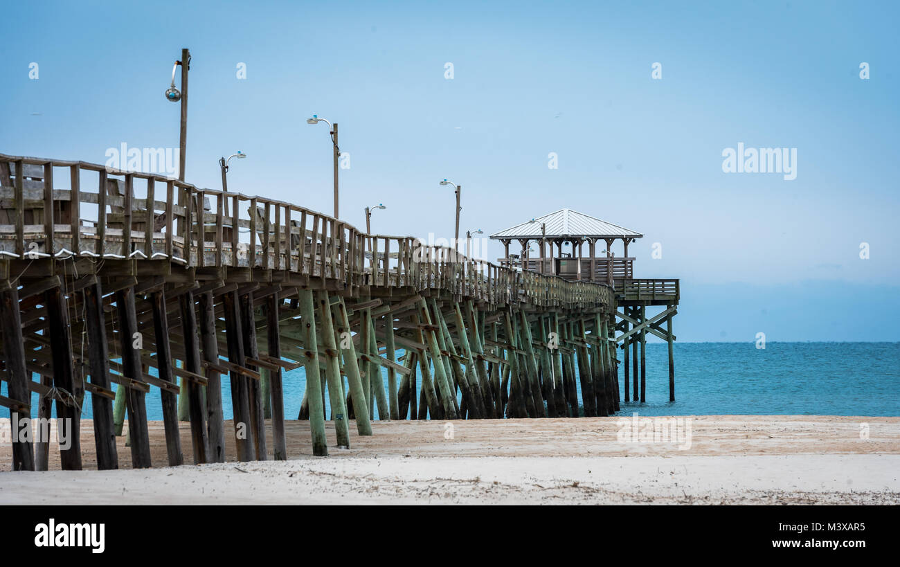 Sunrise with the Atlantic Beach pier in the background with sand, ocean ...