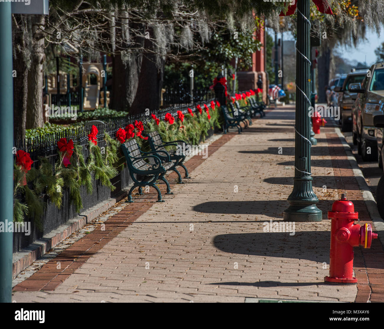 Street decorated with red ribbons and barlands for the Christmas season ...
