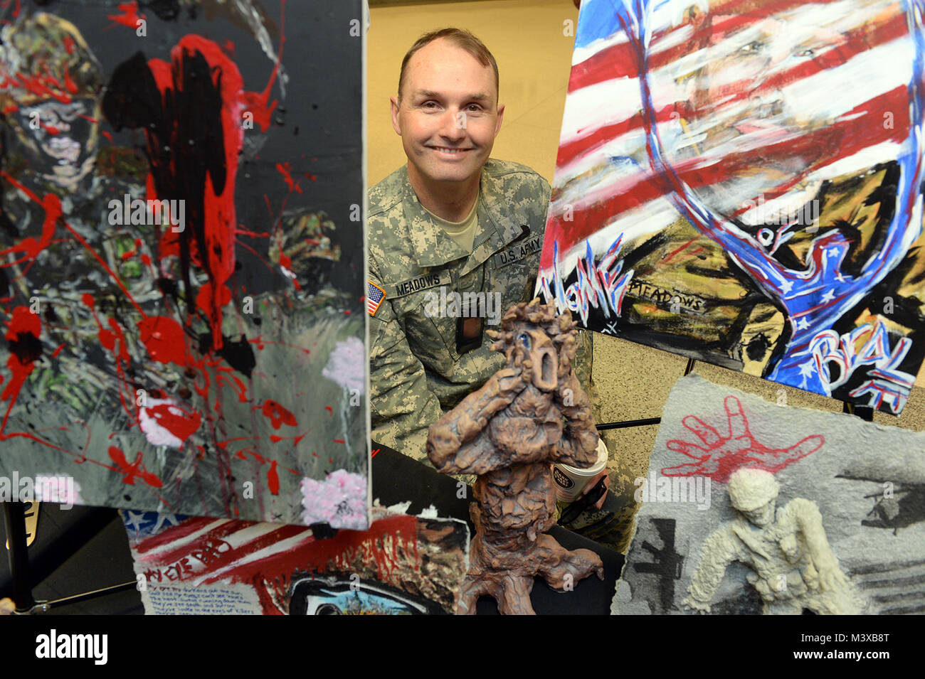 Staff Sgt. Jonathan K. Meadows poses for a photo by his artwork on ...