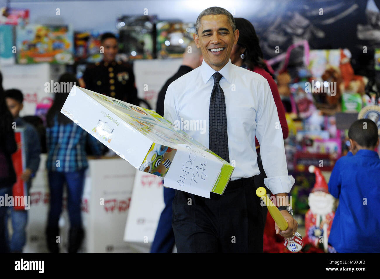 President Barack Obama carries toys donated to the U.S. Marine Corps ...