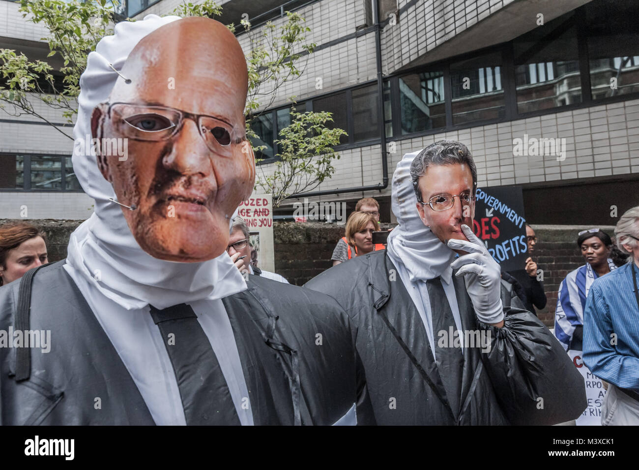 Two men in inflatable chub suits and masks of Vedanta owner Anil ...