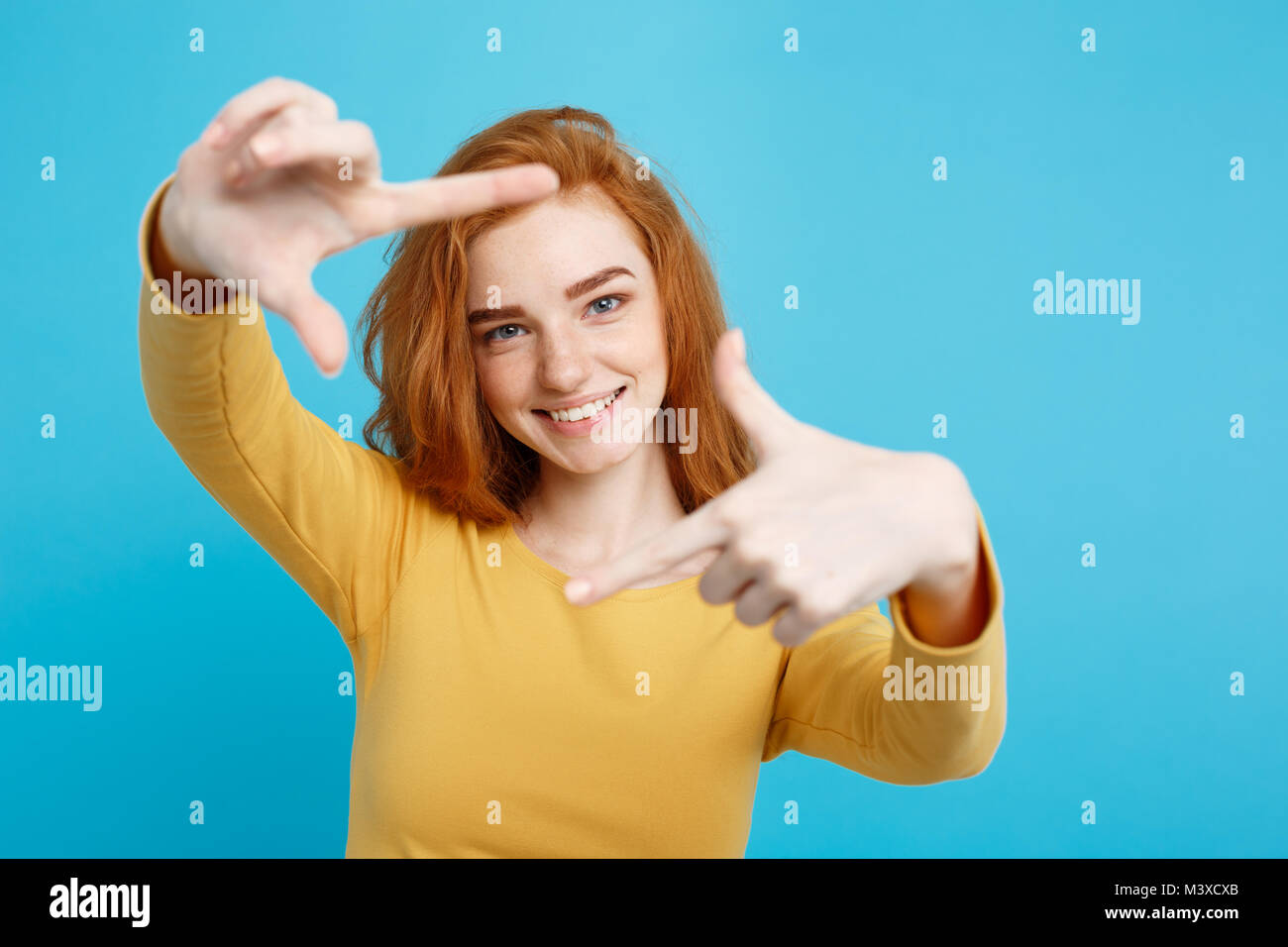 Portrait of young beautiful ginger woman with freckles cheerfuly ...