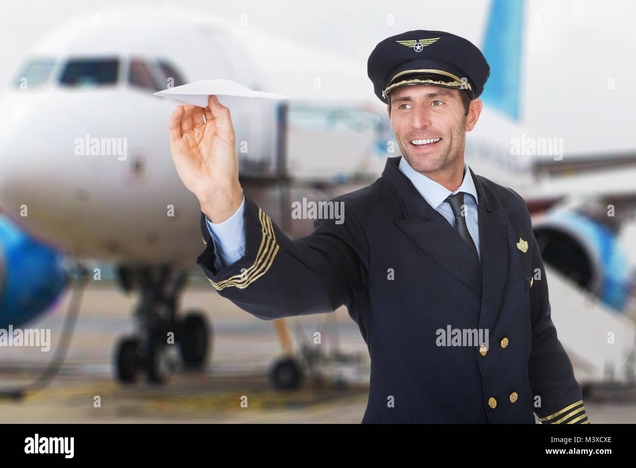 Portrait Of A Smiling Male Pilot Flying Paper Airplane Stock Photo - Alamy