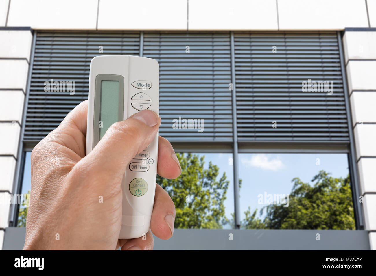 Close-up Of A Person's Hand Using Remote To Open Window Shutter Stock ...