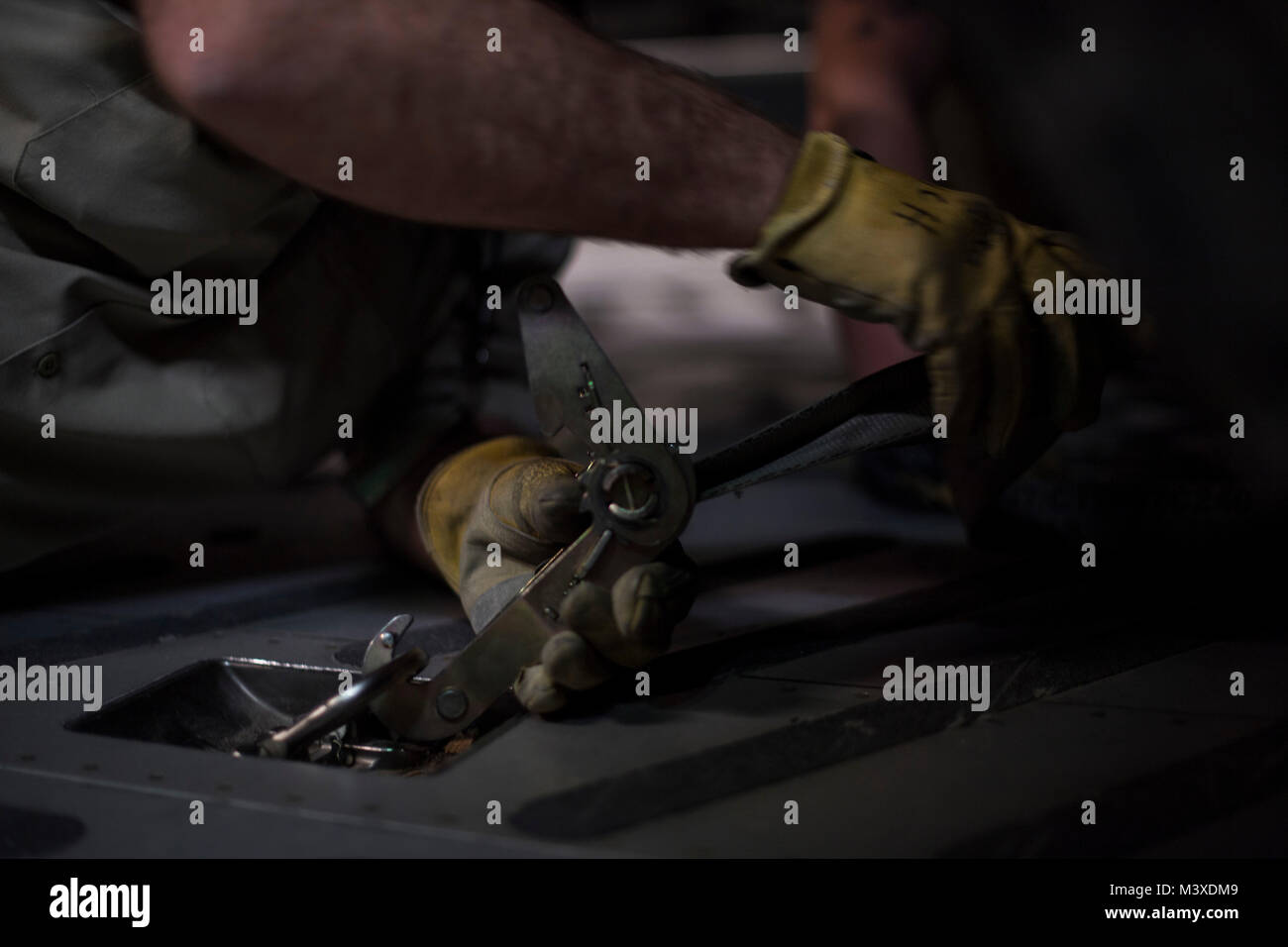 A U.S. Air Force air transportation team member tightens movement ...