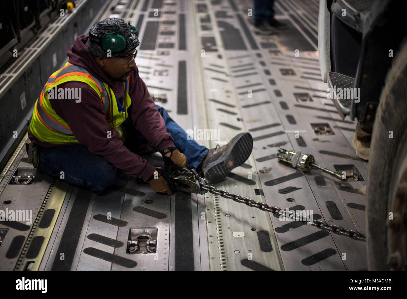 A U.S. Air Force air transportation team member tightens movement ...