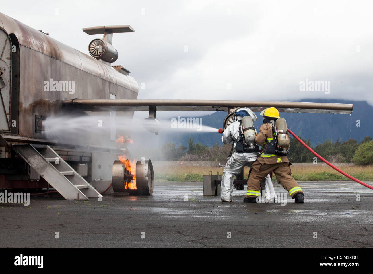 U.S. Marines with Aircraft Rescue Fire Fighting (ARFF) extinguish a ...