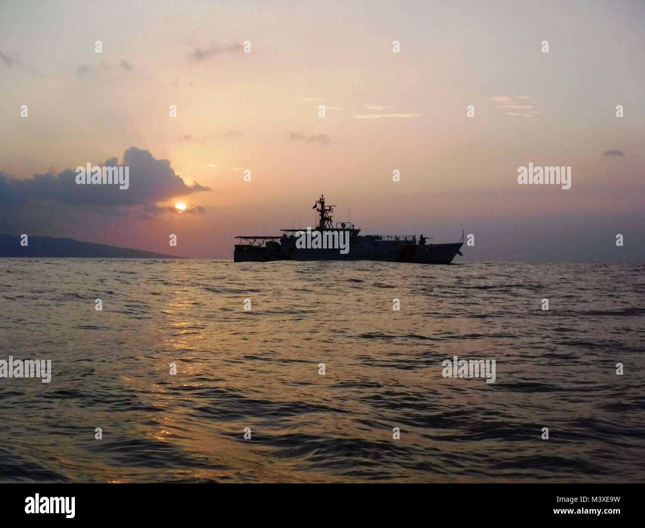 The Coast Guard Cutter Oliver Berry (WPC 1124) patrols during sunset in ...