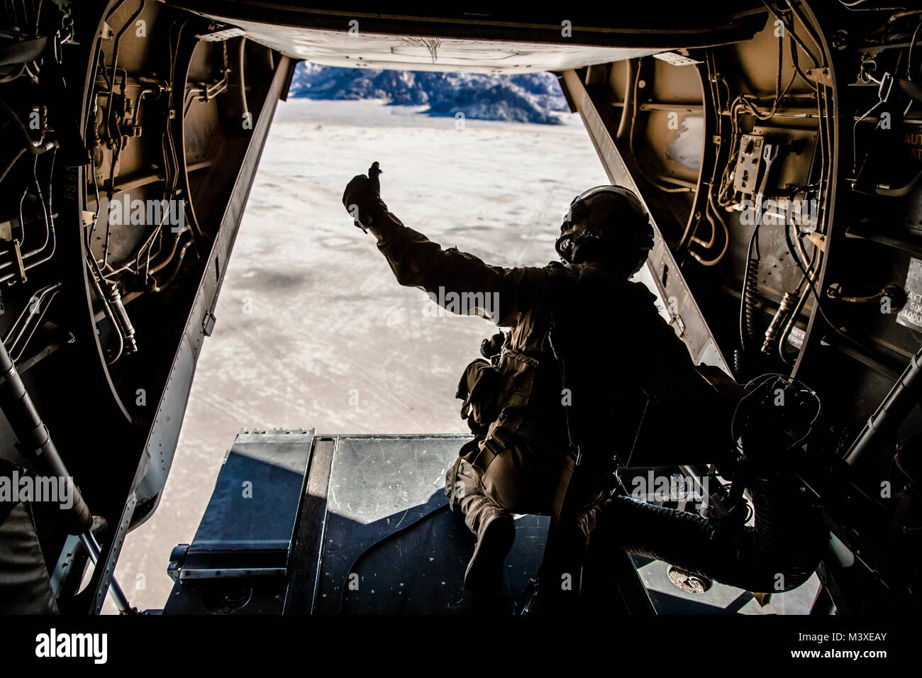 A Marine with Marine Wing Support Squadron 371 scans the skies in an MV ...