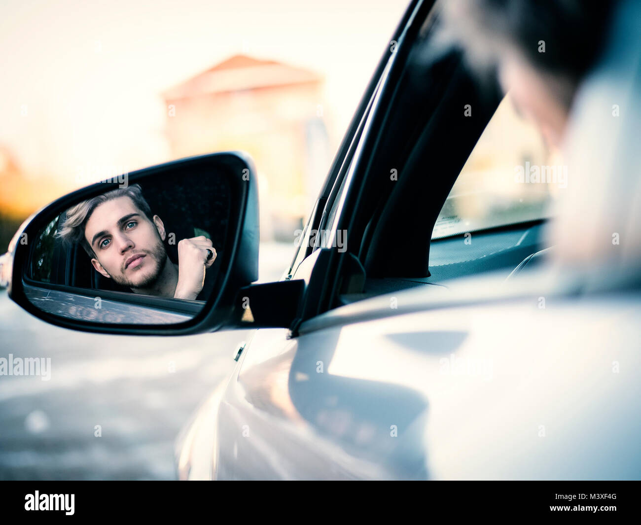 Handsome Blond Young Man Driving a Car, Seen in the Rear Mirror Stock ...