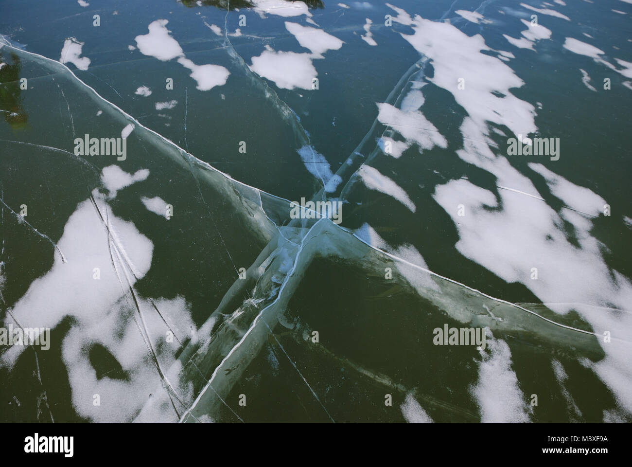 frozen ice on the lake with a huge break in the winter Stock Photo - Alamy