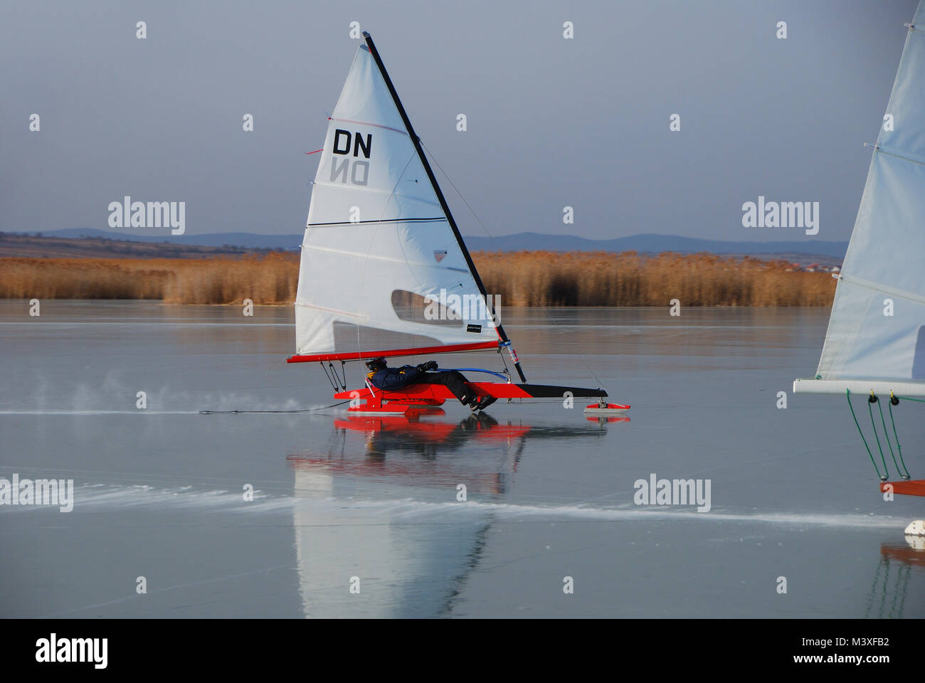 single high-speed ice boaters on glassy frozen lake in winter Stock ...