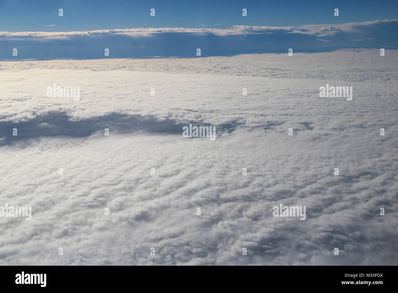 Cloud texture and blue sky during sunrise viewed from airplane Stock ...