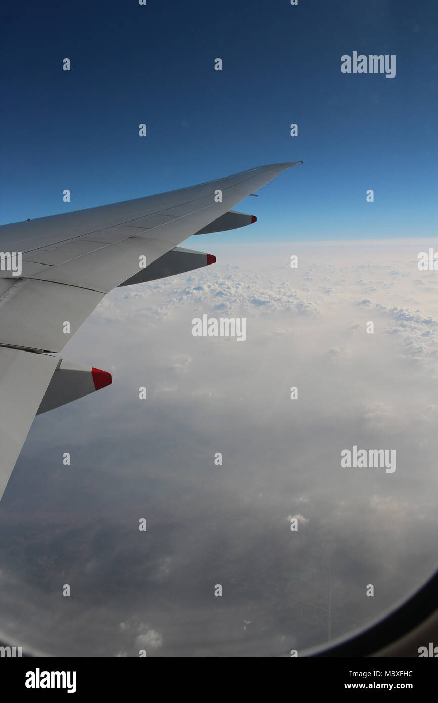 Cloud texture and blue sky with wing during sunrise viewed from ...